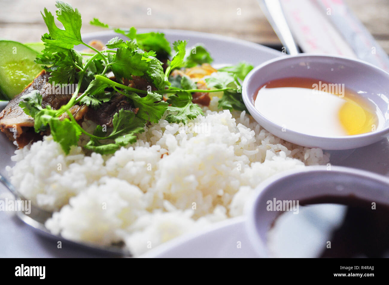 Vietnamese broken rice or com tam with fried chicken legs, pork and ...