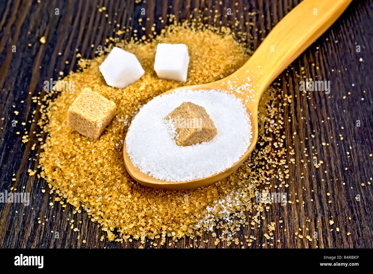 Sugar brown and white in cubes, granulated in a spoon on the background ...