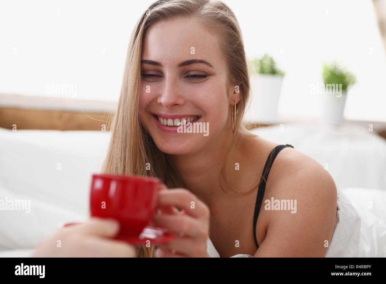 blond woman have cup of tea coffee early morning in her bed Stock Photo ...