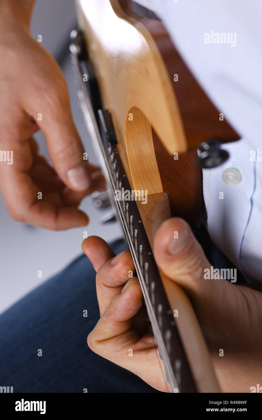 Male arms playing classic shape electric guitar Stock Photo - Alamy