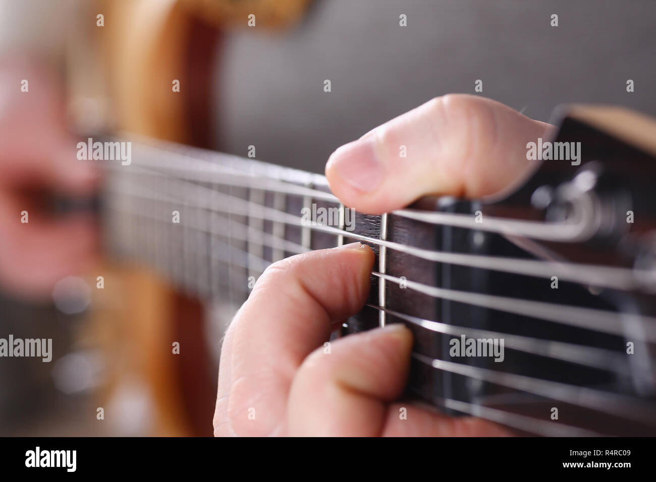 Male arms playing classic shape electric guitar Stock Photo - Alamy
