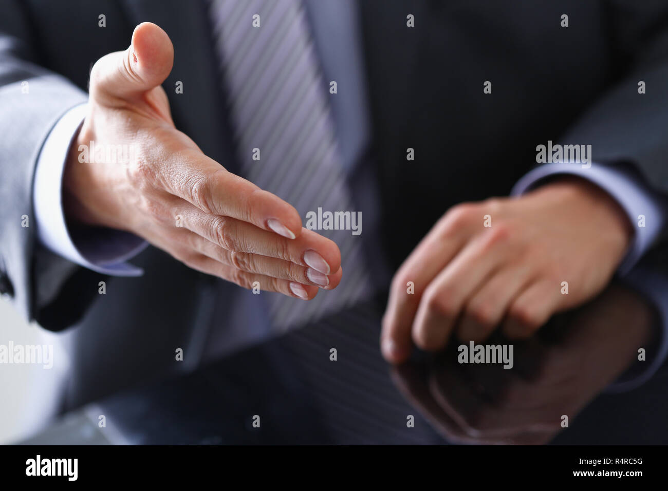 Man in suit and tie give hand as hello Stock Photo - Alamy