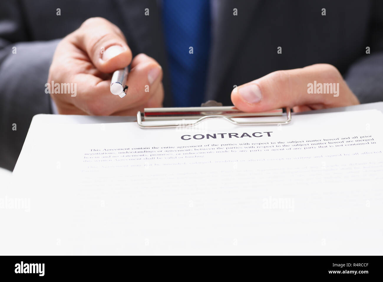 Male arm in suit offer contract form on Stock Photo - Alamy