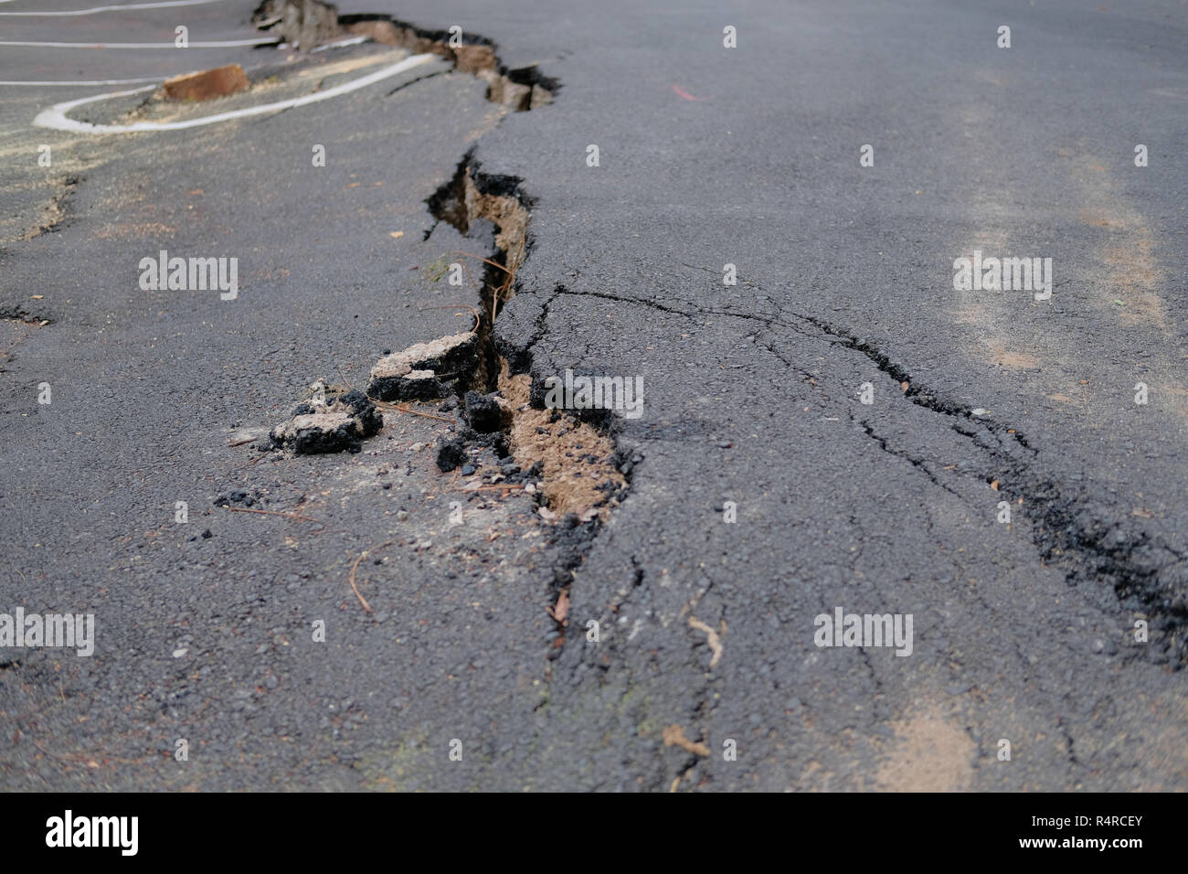 cracks on asphault rural road. damaged collapsed street Stock Photo - Alamy