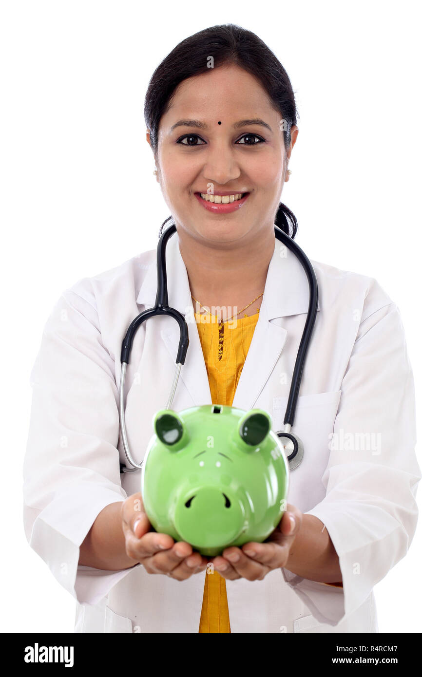Female doctor smiling holding piggy hi-res stock photography and images ...