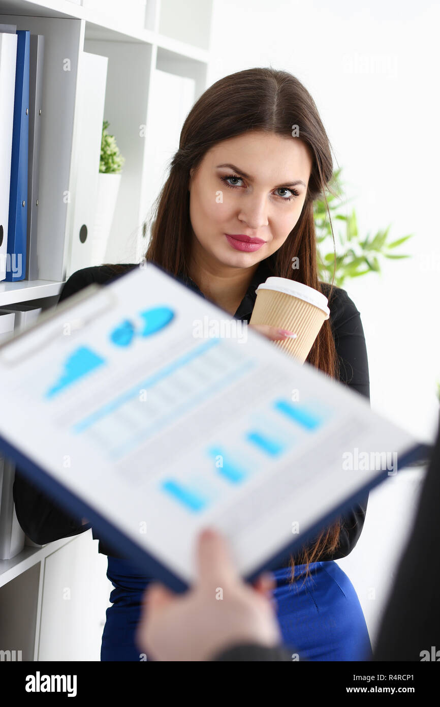 Beautiful smiling clerk girl at workplace talk to visitor Stock Photo ...