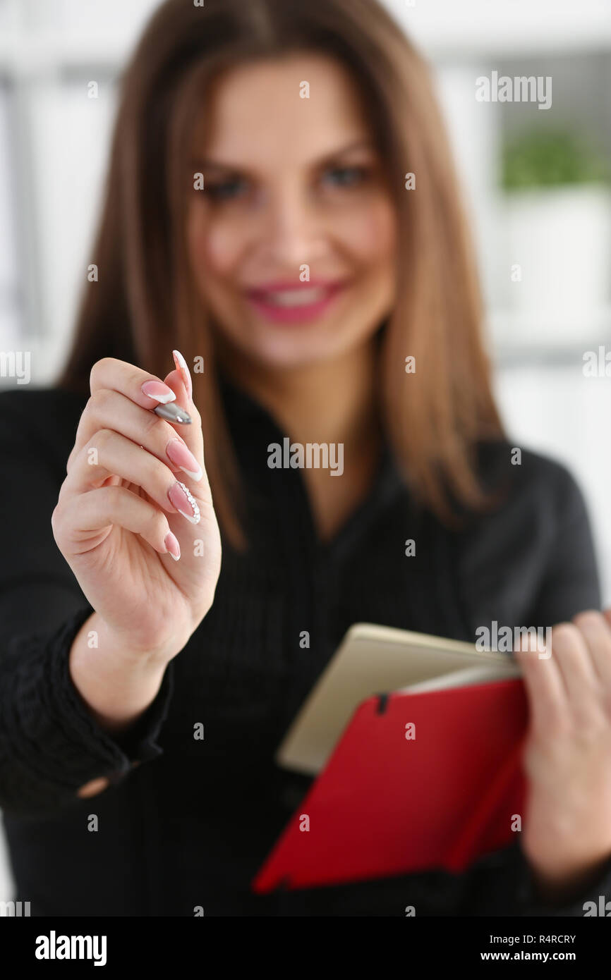 Woman hand holding silver pen ready to make Stock Photo - Alamy