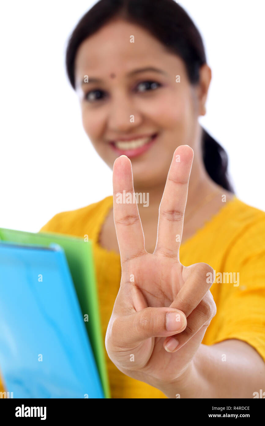 Happy female student with victory gesture Stock Photo - Alamy