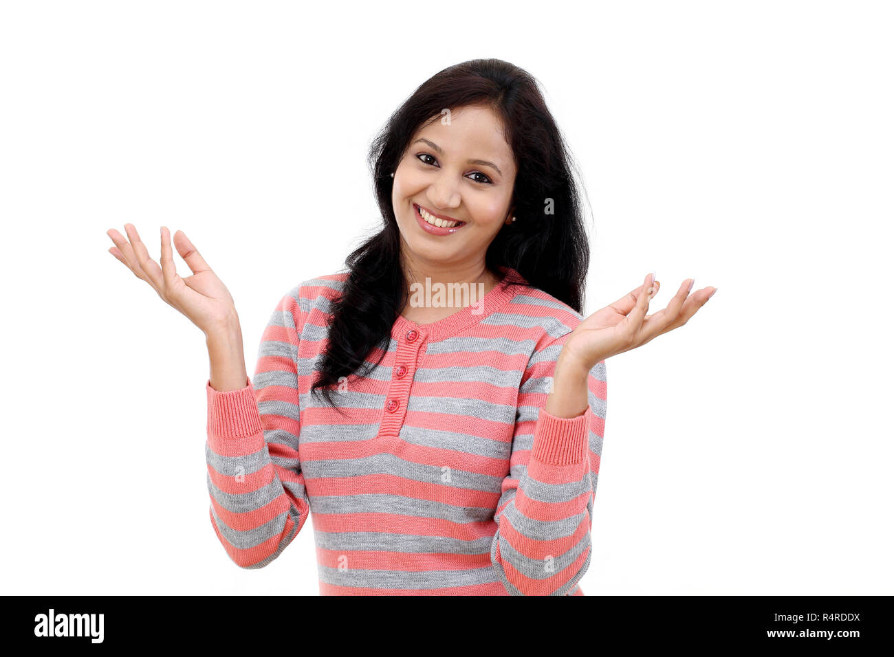 Happy young woman gesturing an open hands against white background ...