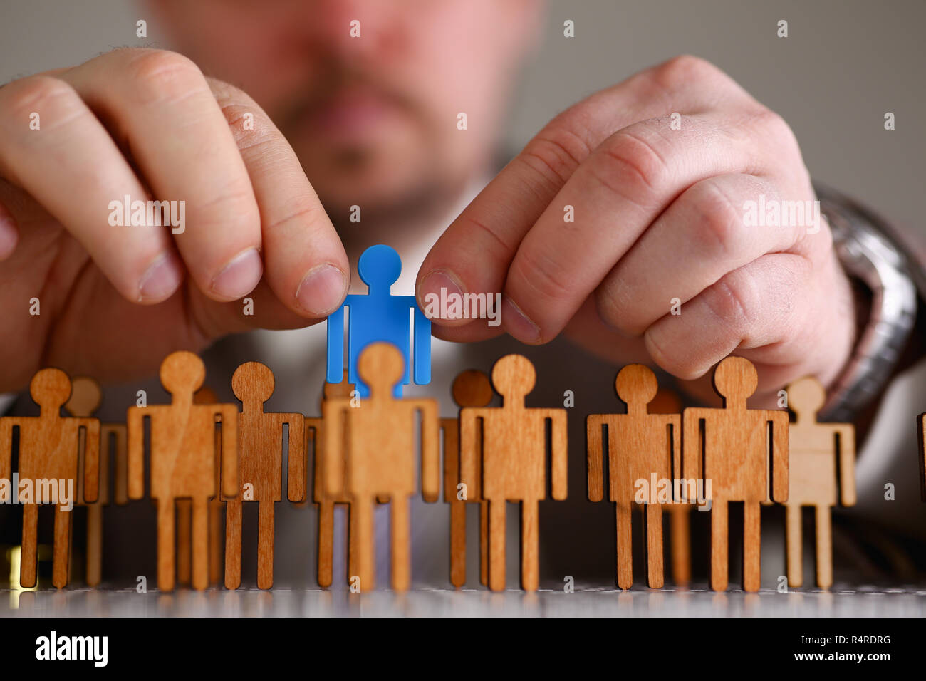 Man arm in suit take little plastic toy figure Stock Photo - Alamy