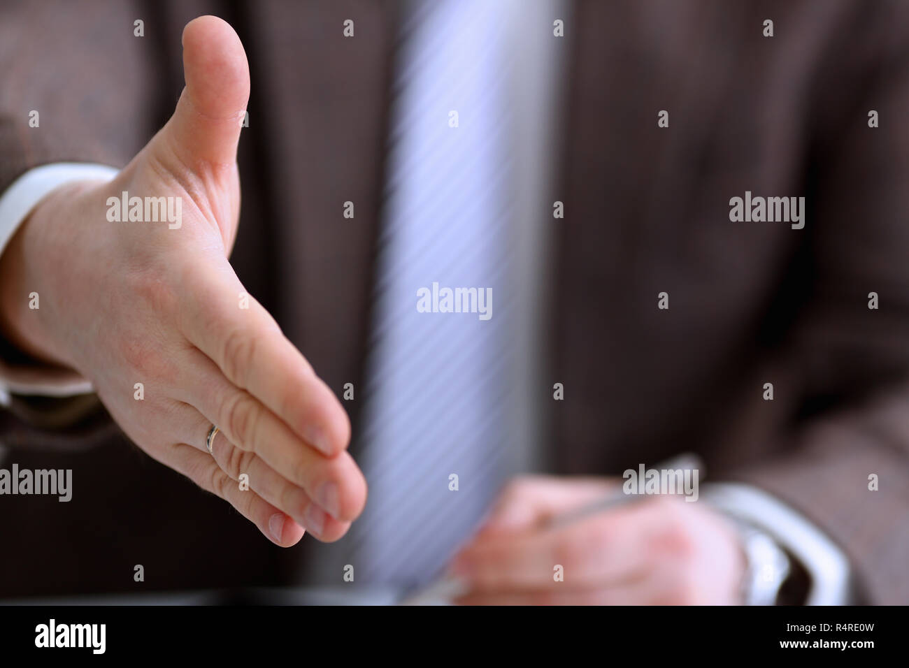 Man in suit and tie give hand as hello Stock Photo - Alamy