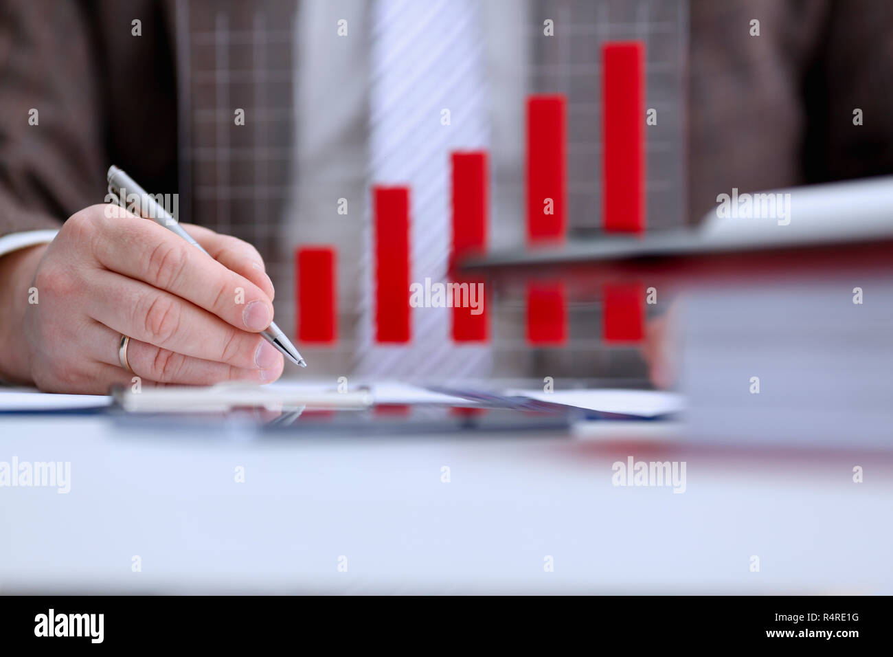 Male arm in suit and tie hold silver pen filling schedule Stock Photo ...