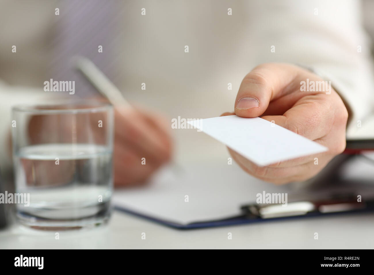 Male arm in suit give blank calling card to visitor Stock Photo - Alamy