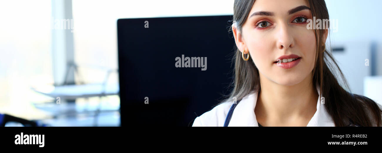 Beautiful smiling female doctor sit at workplace Stock Photo - Alamy