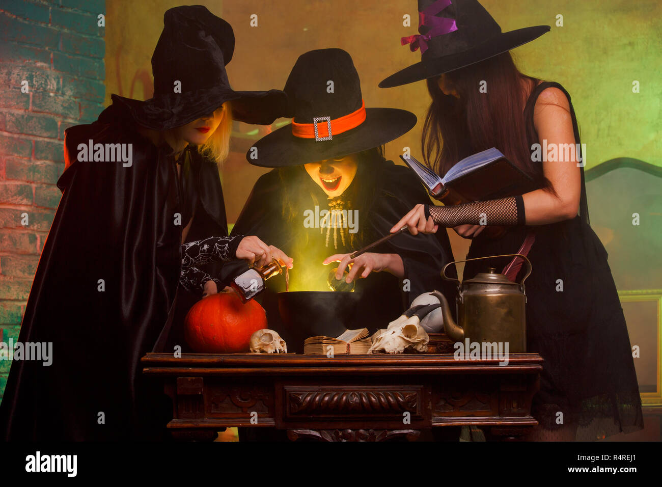 Picture of three witches boiling potions in cauldron at dark room Stock ...