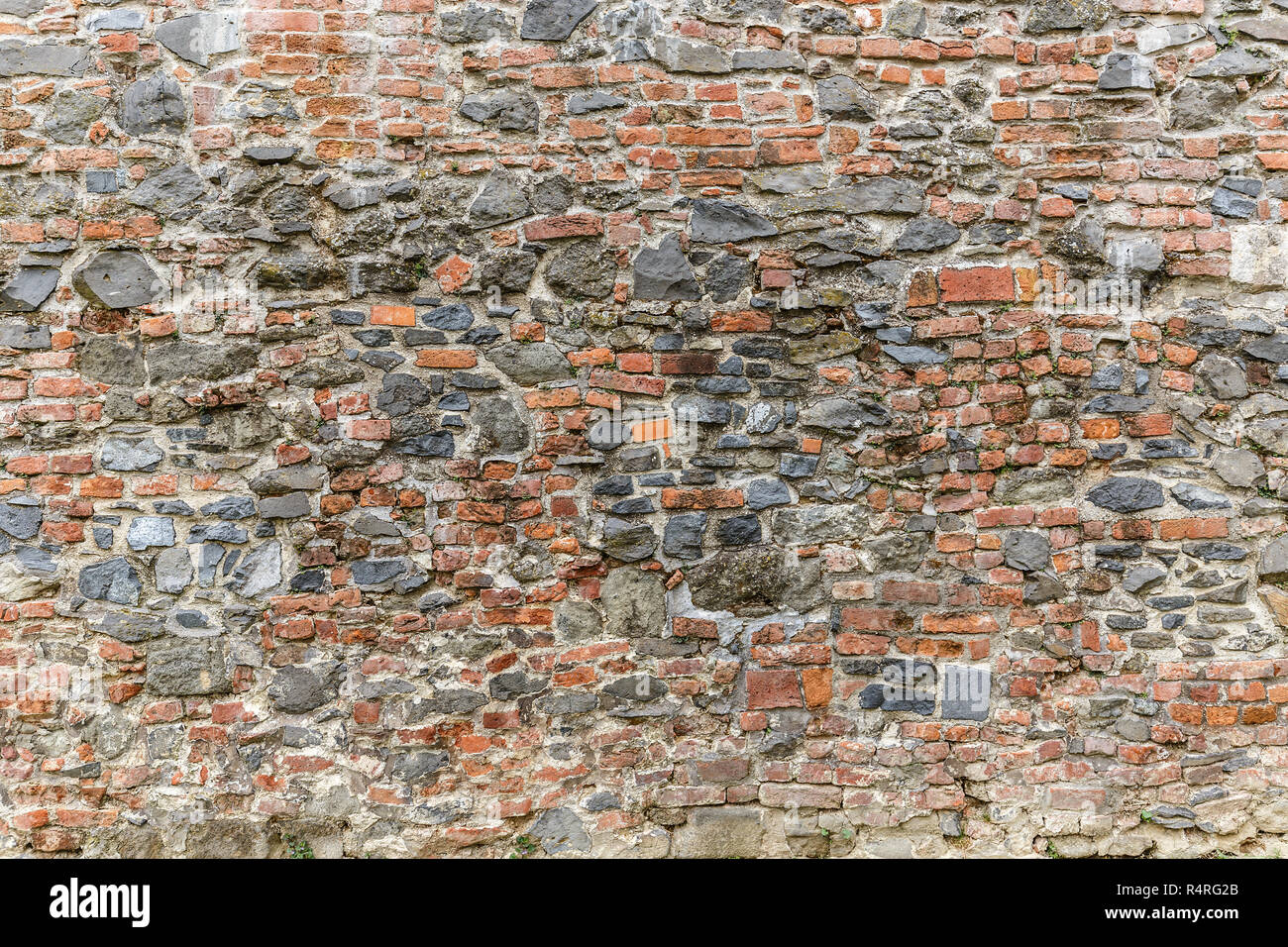 Uneven stone and brick wall Stock Photo - Alamy