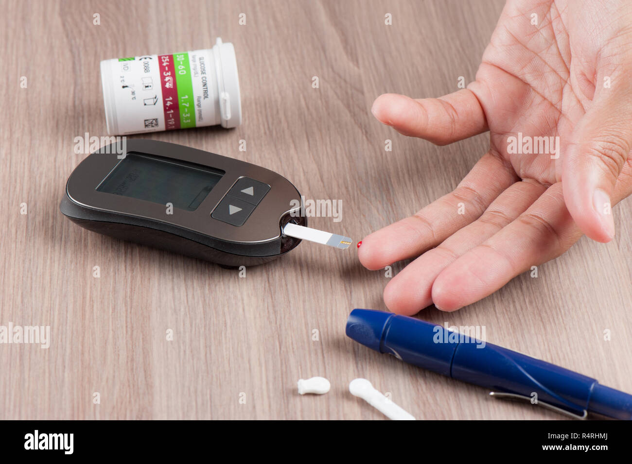 Checking blood sugar level with blood glucose meter Stock Photo - Alamy