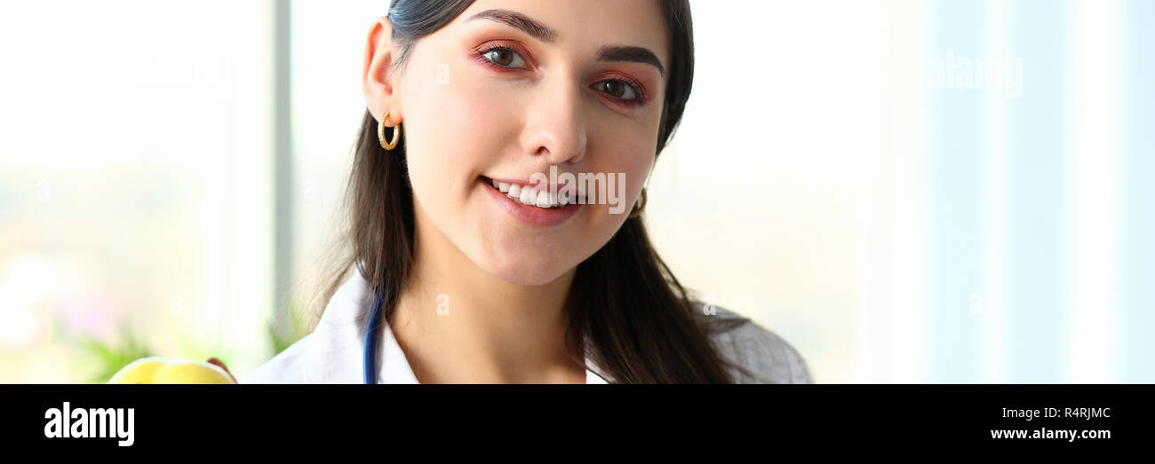 Beautiful smiling female doctor sit at workplace Stock Photo - Alamy