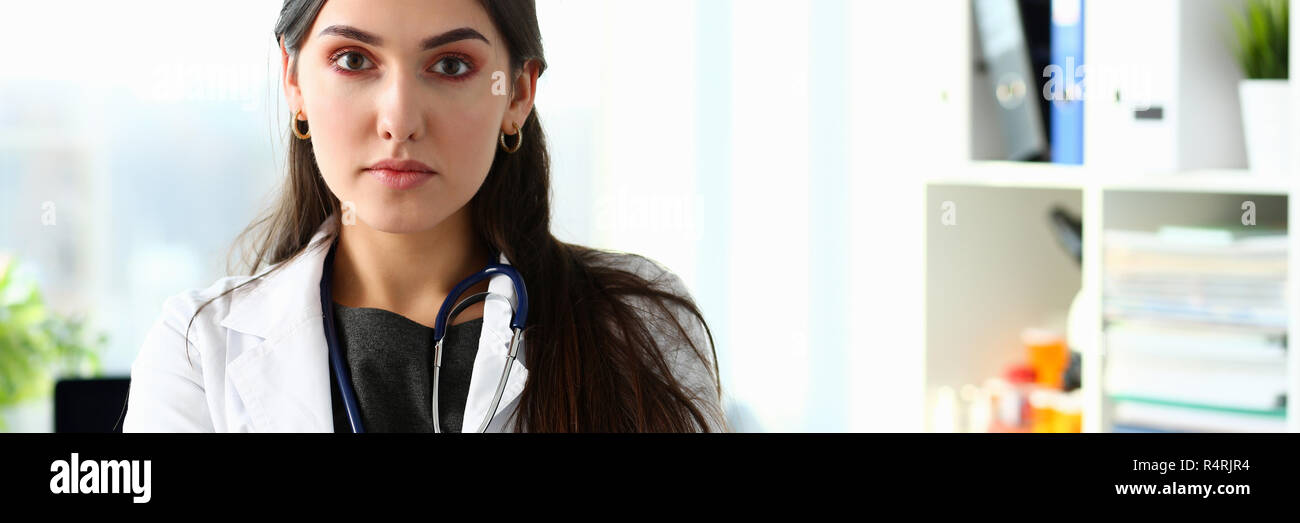 Beautiful smiling female doctor sit at workplace Stock Photo - Alamy