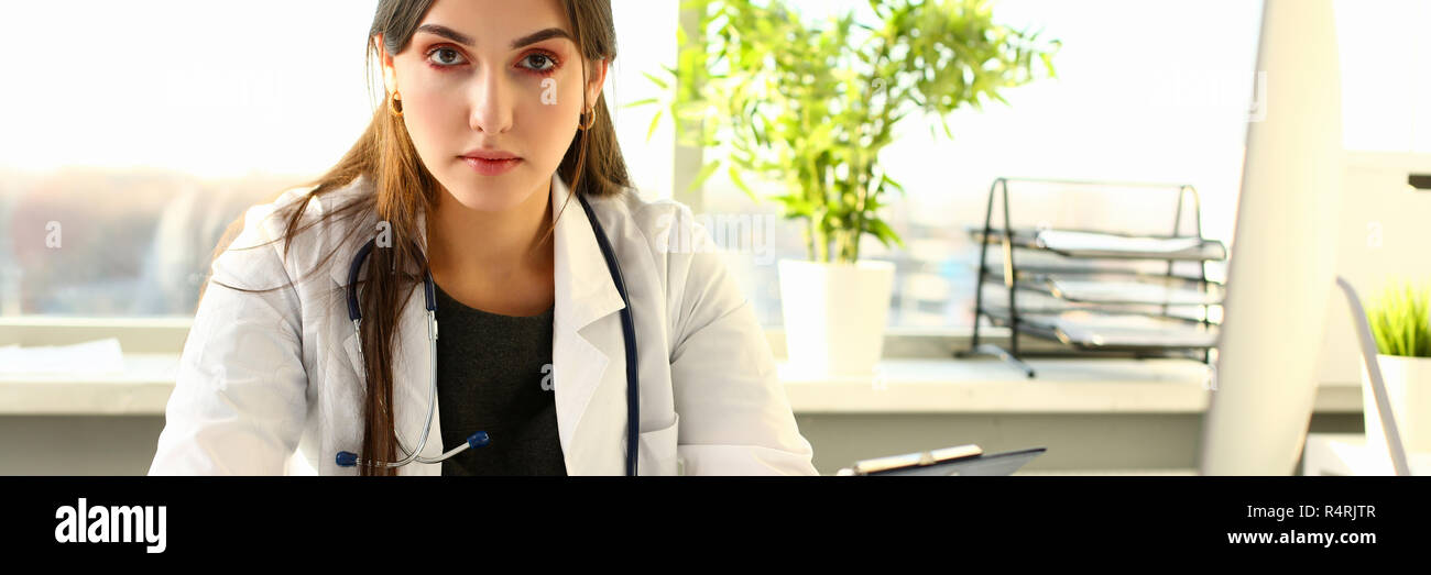 Beautiful smiling female doctor sit at workplace Stock Photo - Alamy