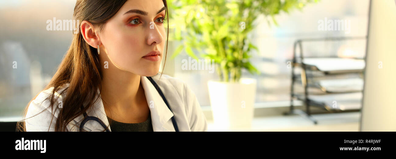 Beautiful smiling female doctor sit at workplace Stock Photo - Alamy