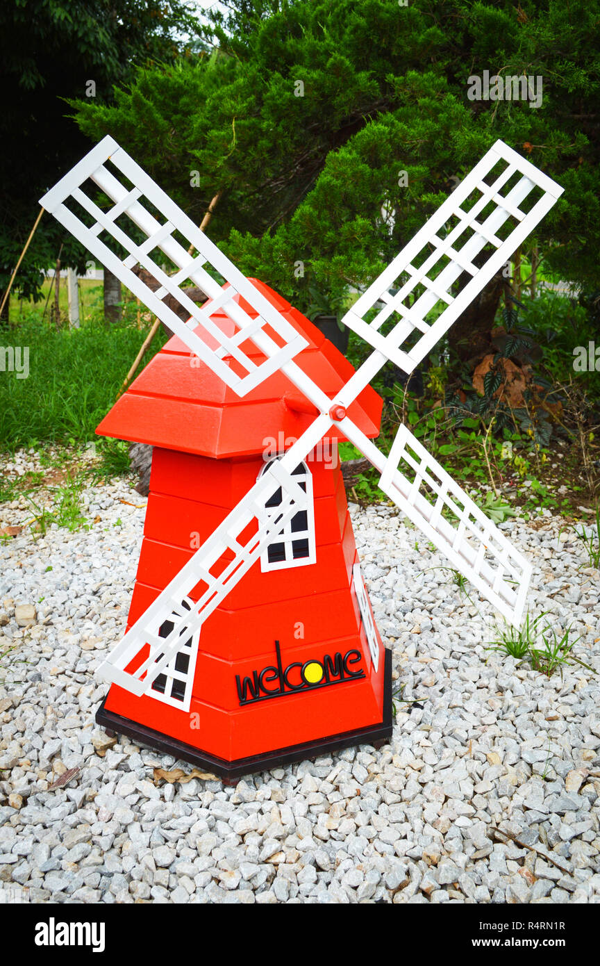 colorful red windmill wind turbine in the park garden - landscape ...