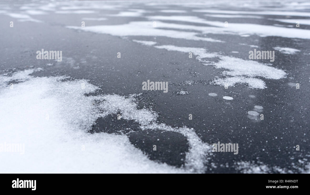 thick solid layer of ice of frozen river with freeze bubbles Stock ...