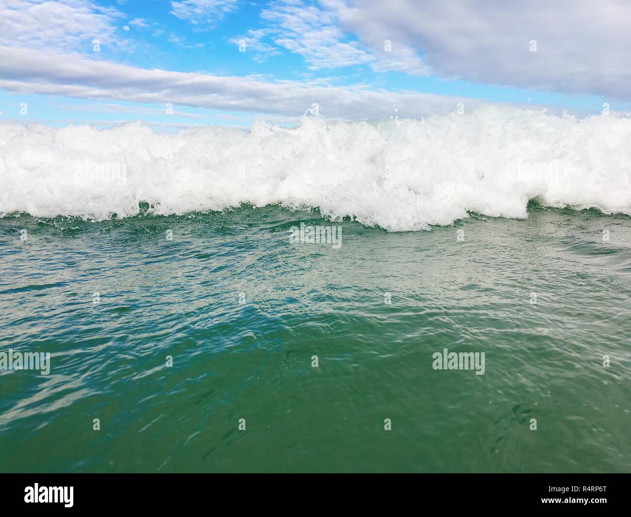 Sea waves reaching lapping to shore Stock Photo - Alamy