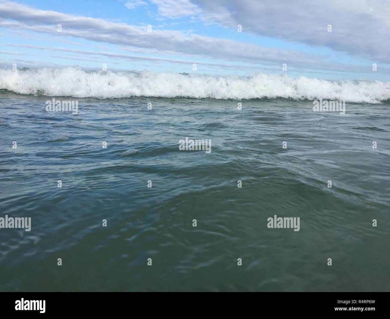 Sea waves reaching lapping to shore Stock Photo - Alamy