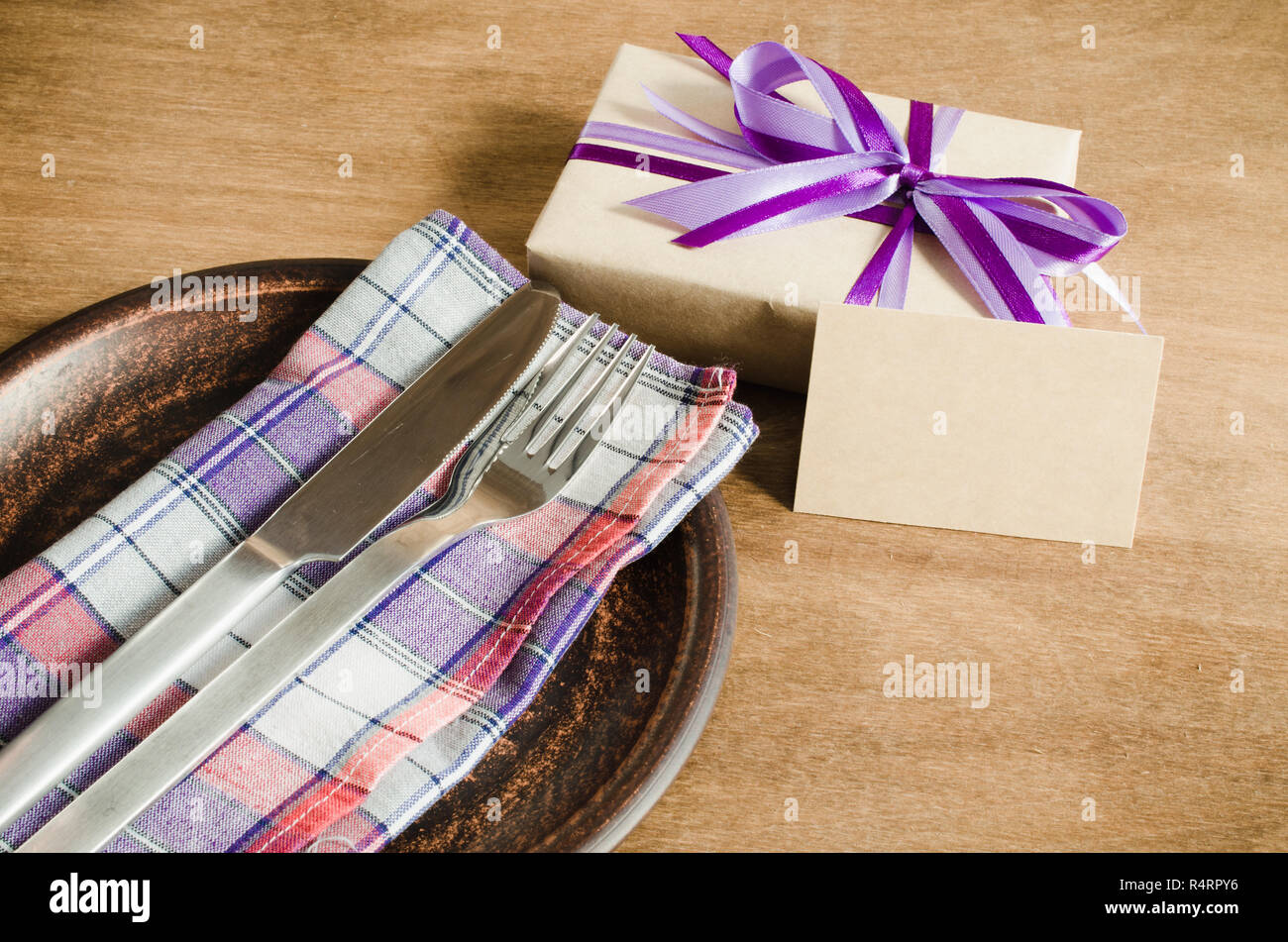 Dining Table Setting with Empty Tag and Present Stock Photo - Alamy