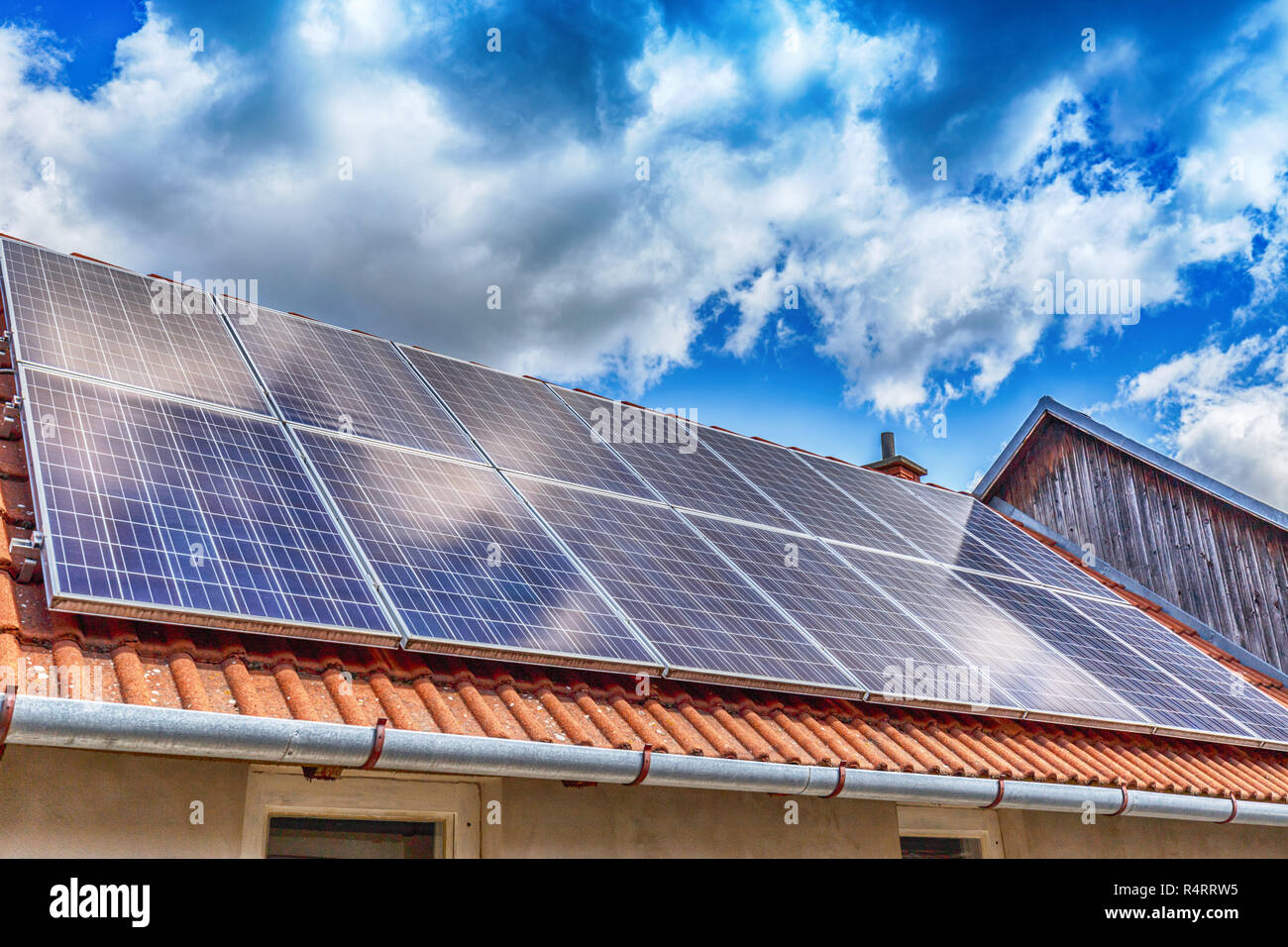 Solar panel on a red roof Stock Photo - Alamy