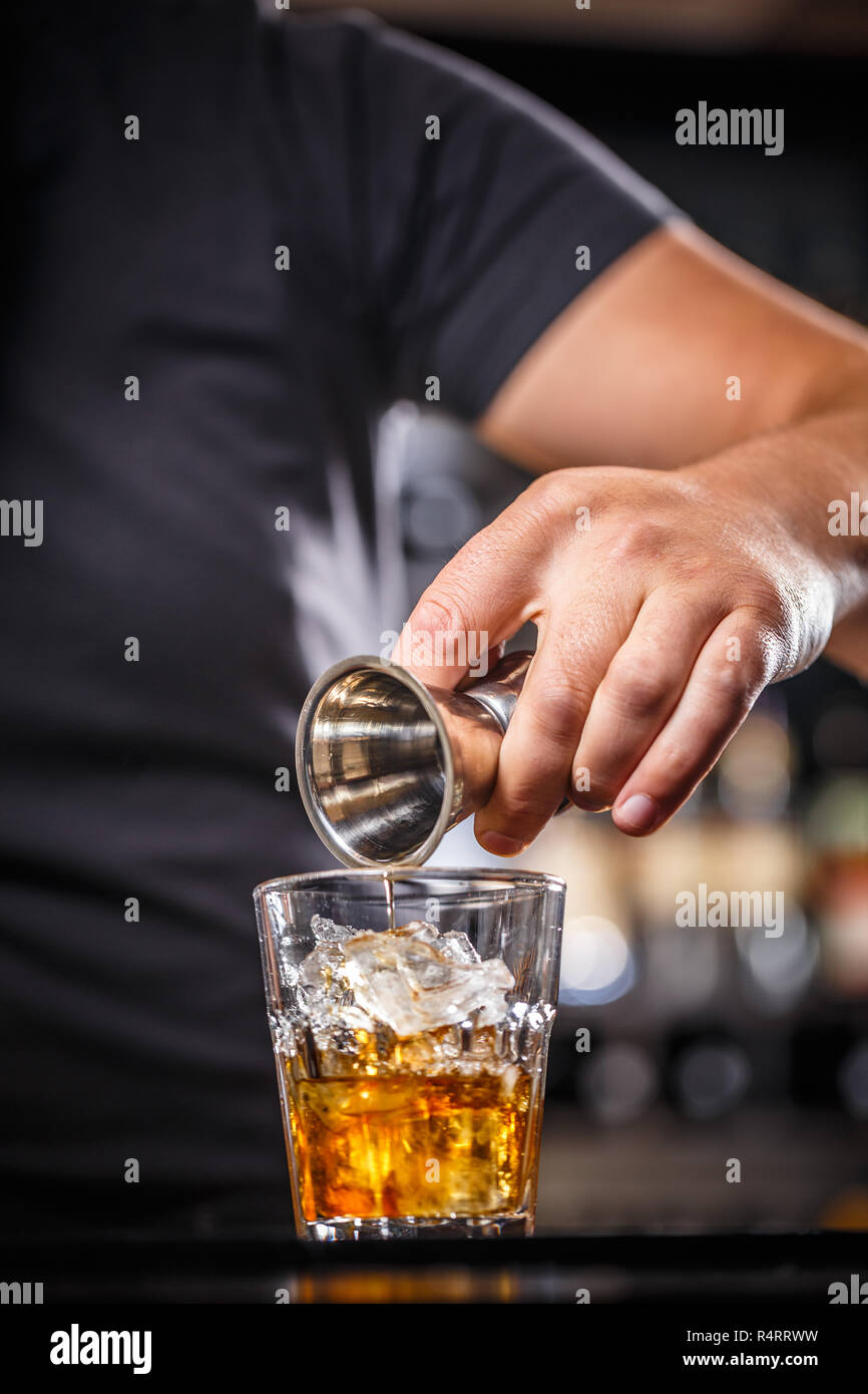Bartender pouring alcohol Stock Photo - Alamy