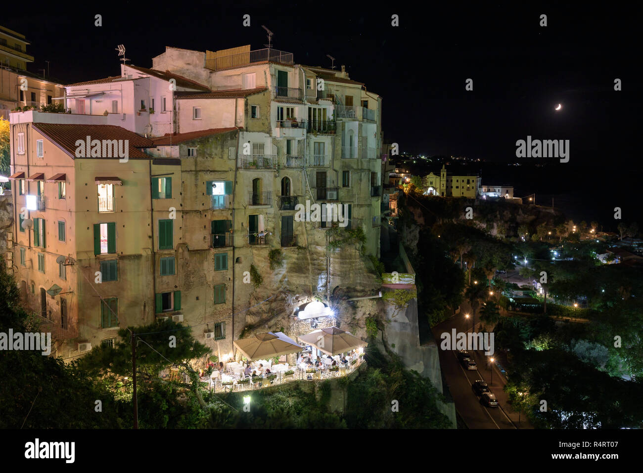 Buildings on a cliff in Tropea by night, Calabria, Italy Stock Photo ...