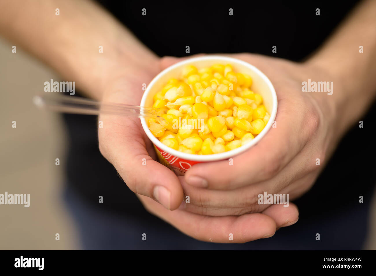 Hands of young man holding cup of deliciously steamed sweet corn Stock ...
