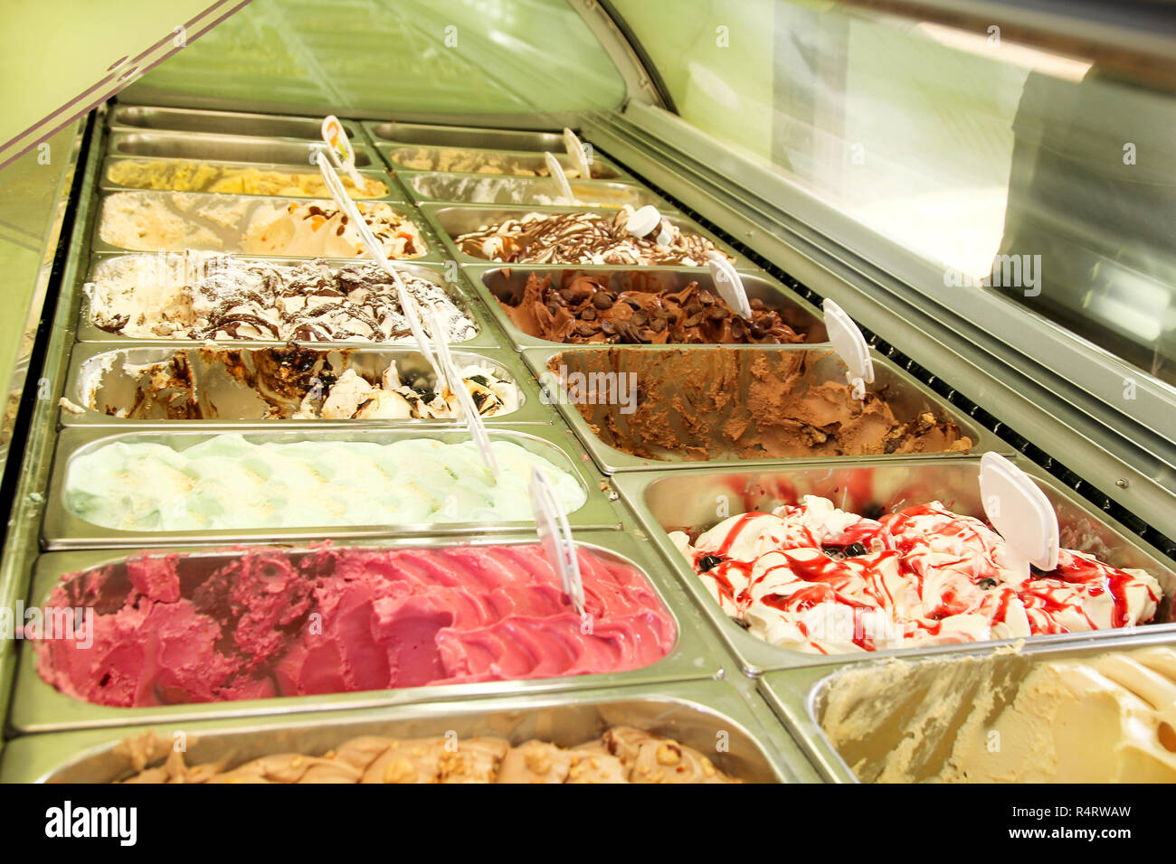 Ice cream fridge with creamy and fruit Italian ice cream steel serving ...