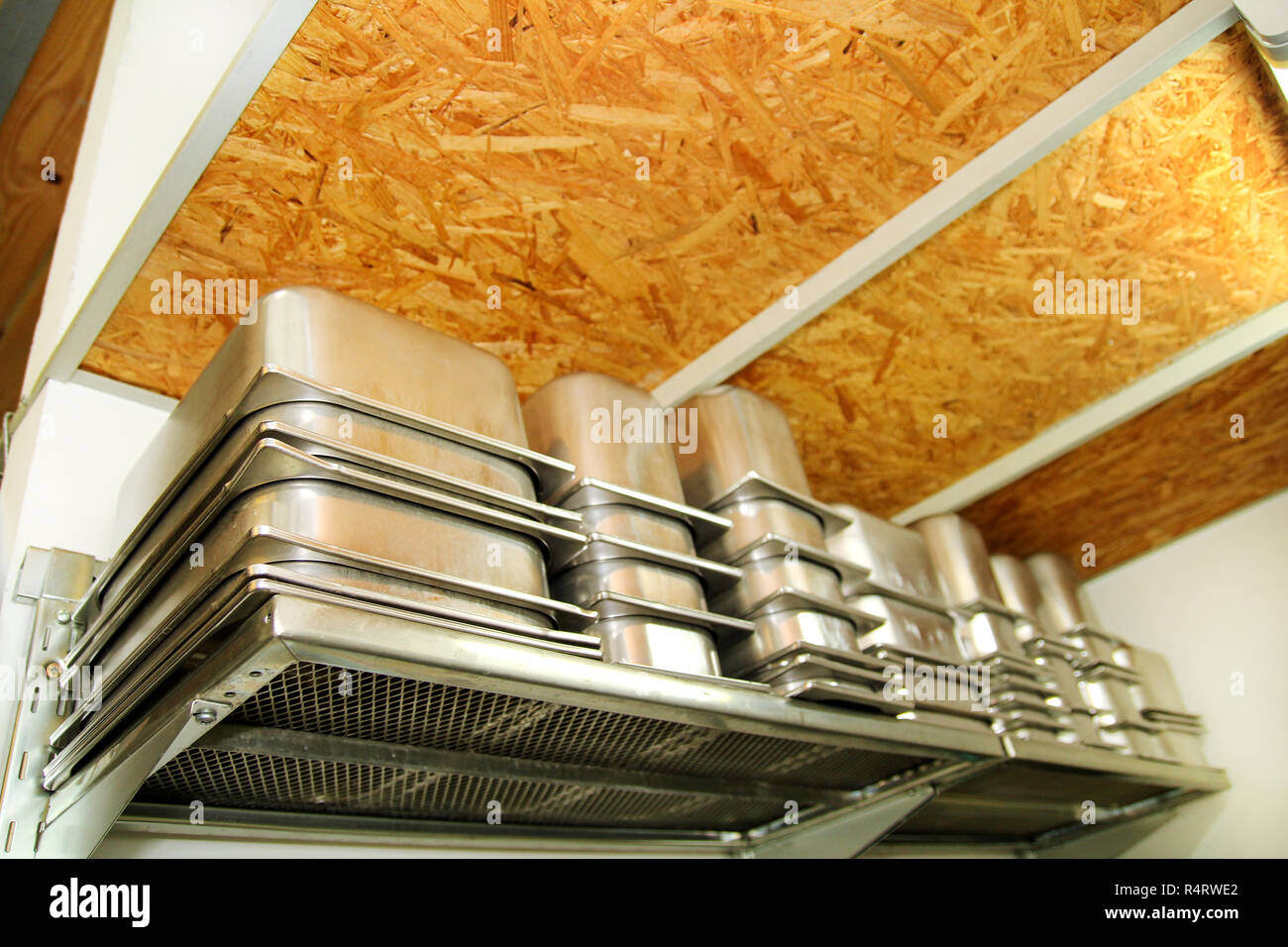 Steel service containers for ice cream packed on stacks on the shelf ...