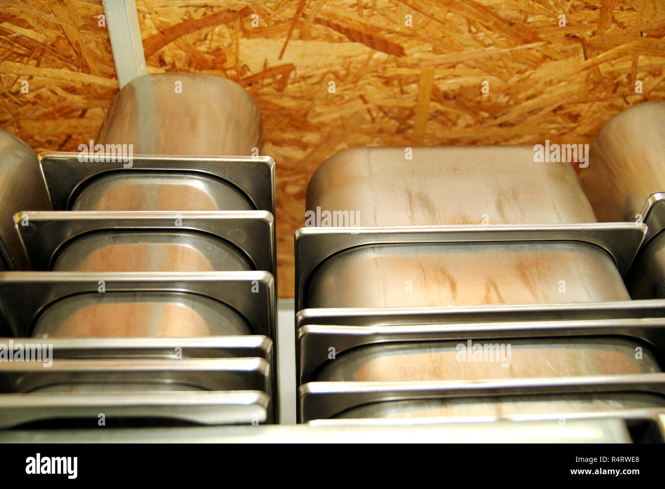 Steel service containers for ice cream packed on stacks on the shelf ...