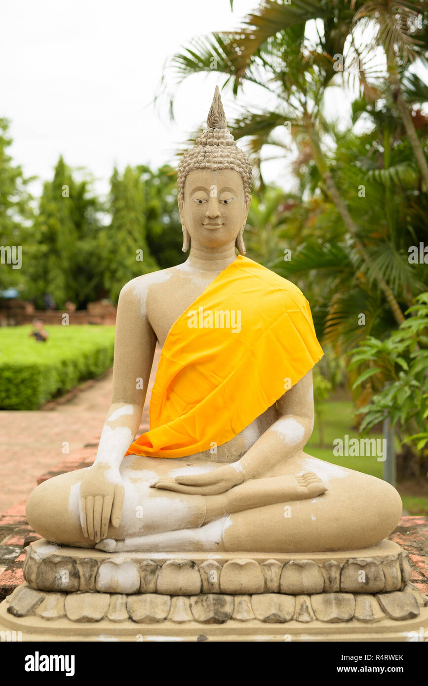 Sculpture of Buddha wearing yellow robe while meditating in Ayut Stock ...
