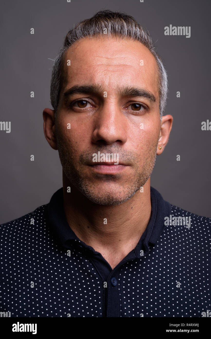 Face of handsome Persian man with gray hair looking at camera Stock ...
