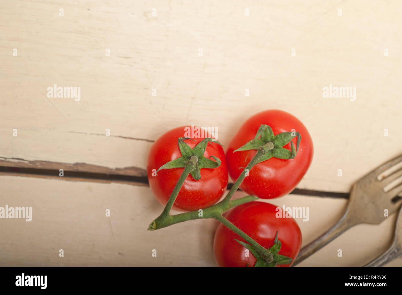 ripe cherry tomatoes over white wood Stock Photo - Alamy
