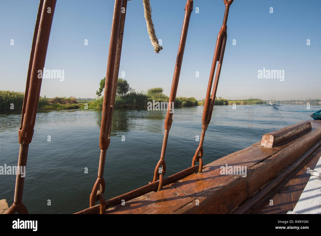 View across large wide river Nile in Egypt to riverbank through rural ...