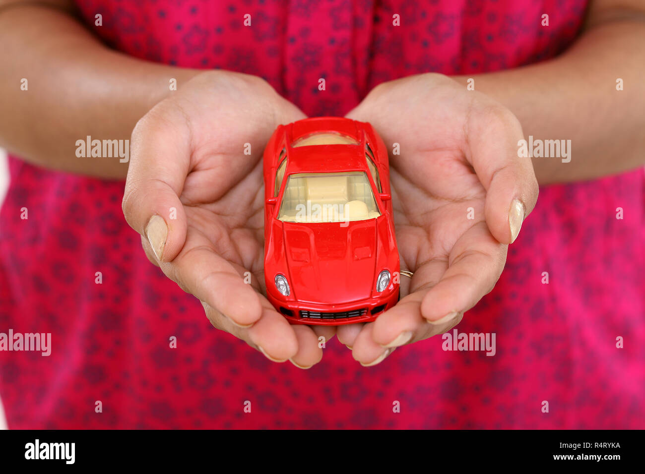 Red toy car in hands Stock Photo - Alamy