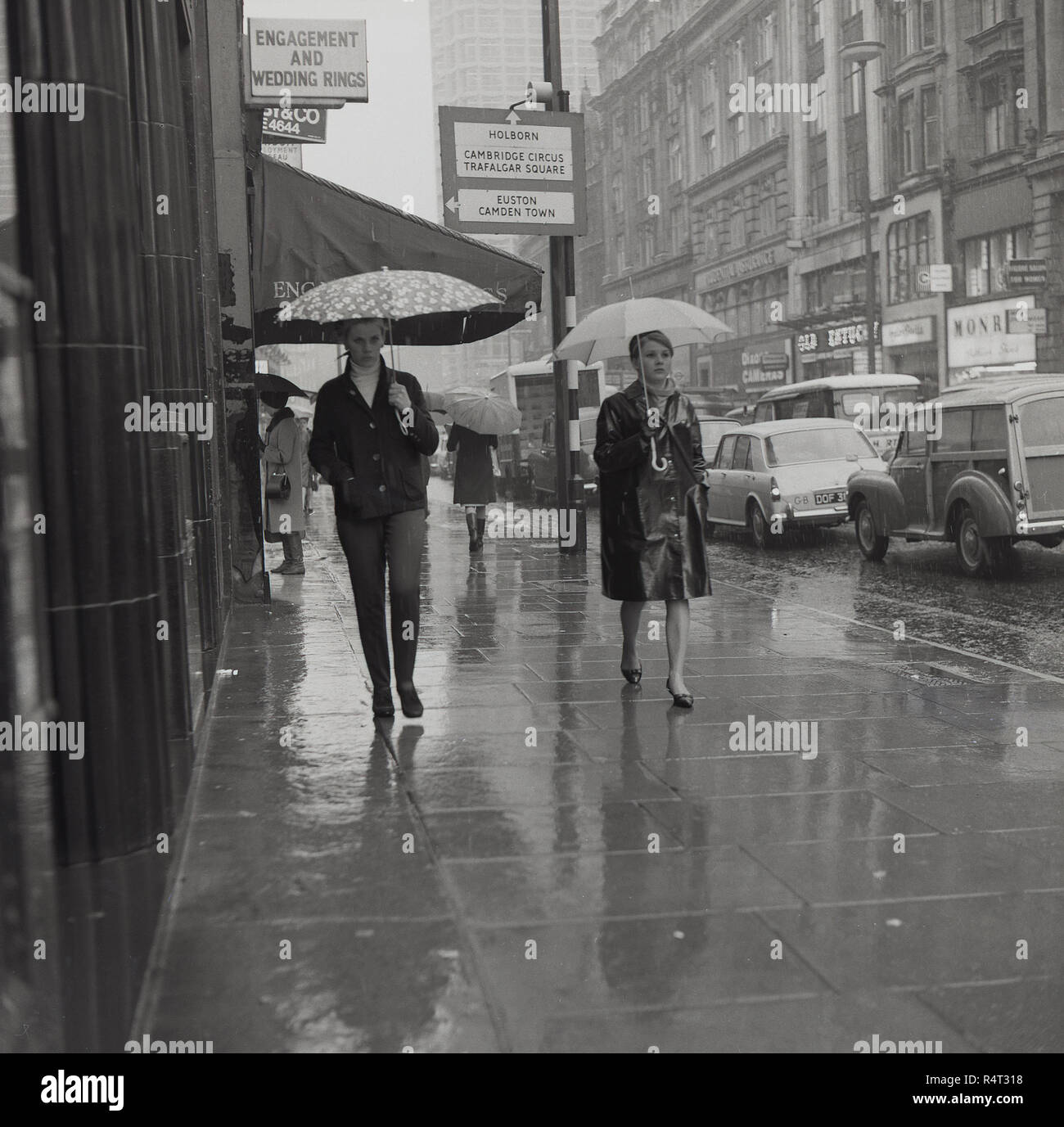 1960s, historical, Central London, two women walking along a wet ...
