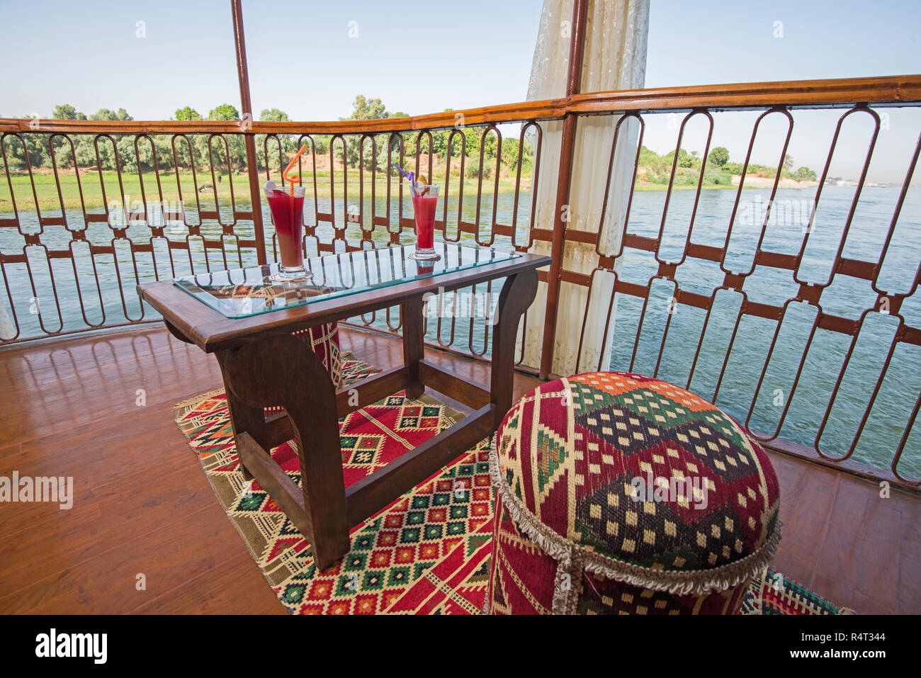 Seating chair and table on the cabin balcony of a luxury nile river ...