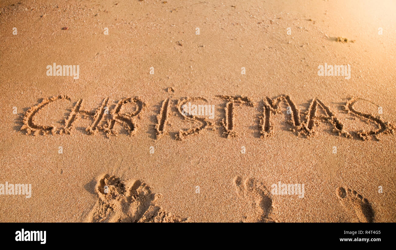 Image of word Christmas written on sand beach at ocean. Concept of ...