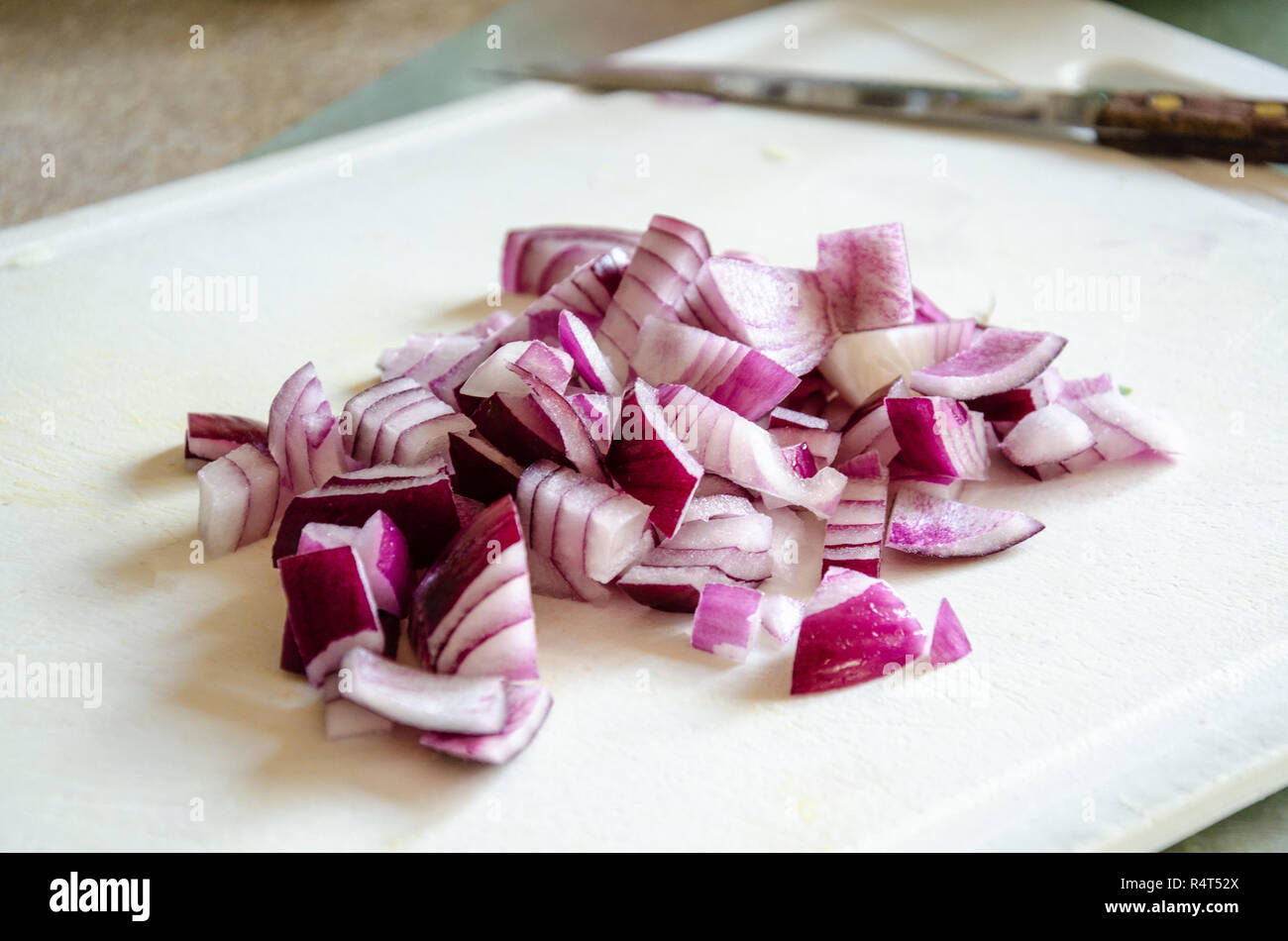 Chopped red onion on a white chopping board Stock Photo - Alamy