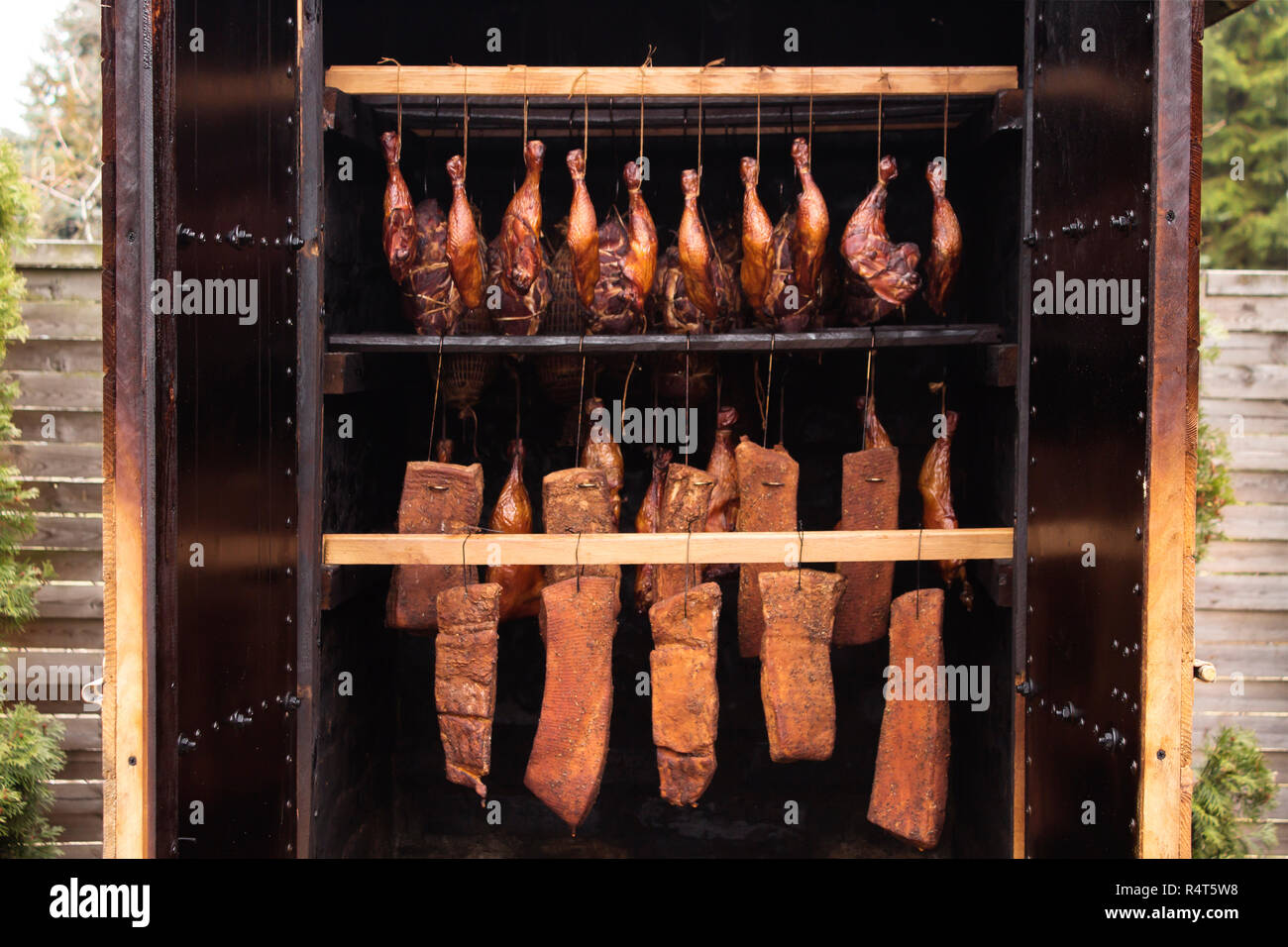 stages of smoking. ready-smoked meat in the smokehouse Stock Photo - Alamy