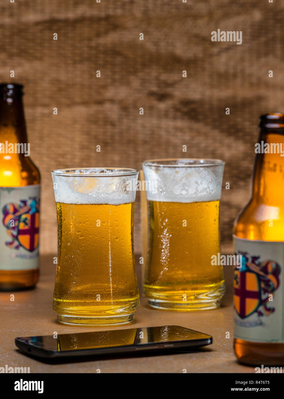 two beer bottles and glasses in pub bar restaurant, various concepts ...