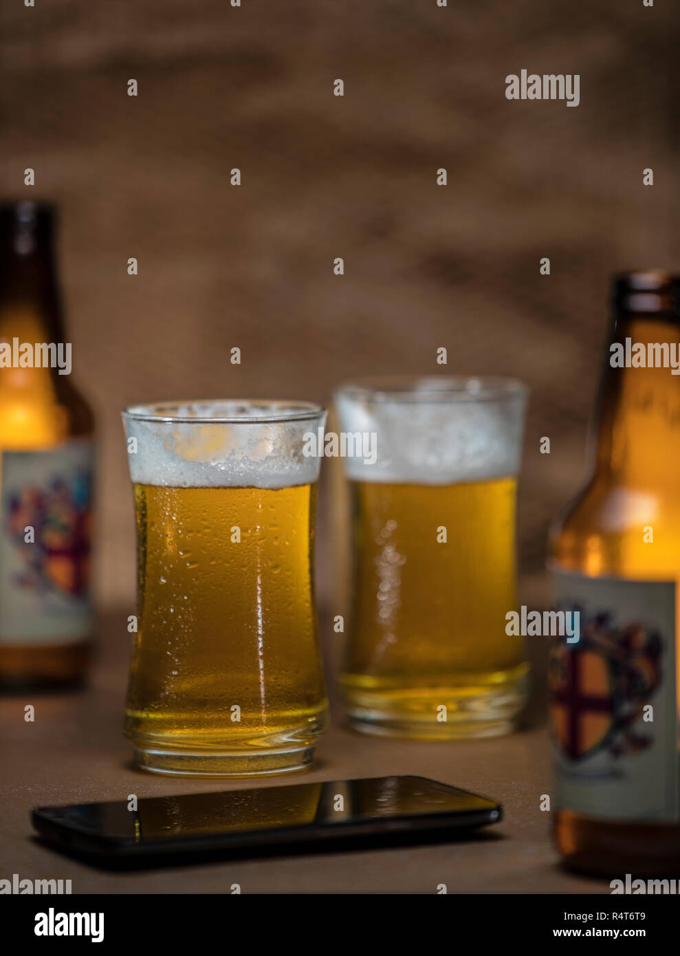 two beer bottles and glasses in pub bar restaurant, various concepts ...