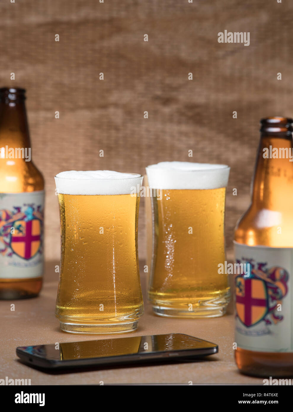 two beer bottles and glasses in pub bar restaurant, various concepts ...